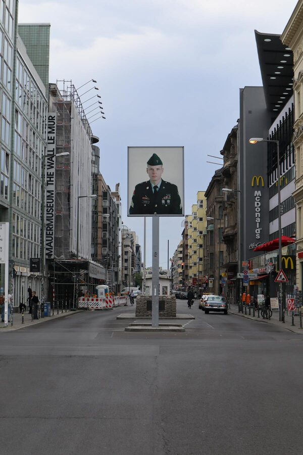 Historic Checkpoint Charlie area in Berlin with old buildings and signage