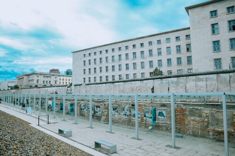 Remaining section of the Berlin Wall with modern city buildings in the background