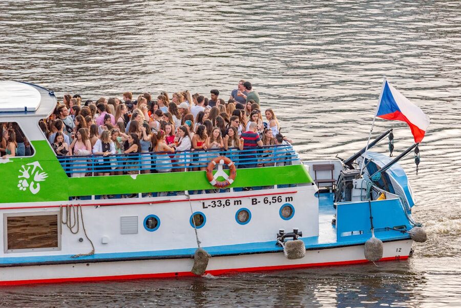 Tour boat on calm river with city view