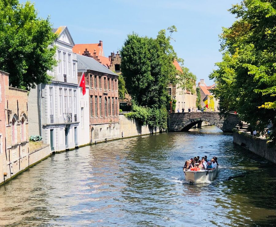 Bruges canal with medieval buildings and trees