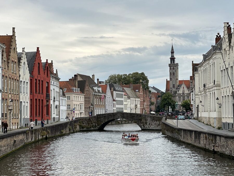 Bruges canal with stone bridge and reflections