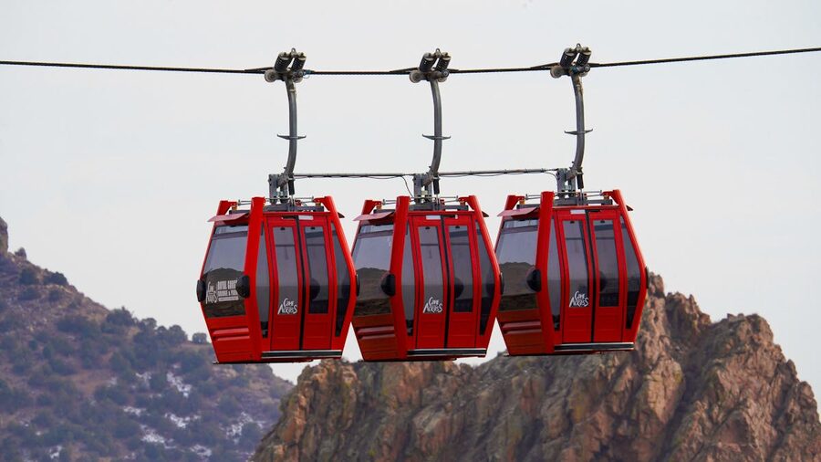 Cable car ascending over mountain terrain