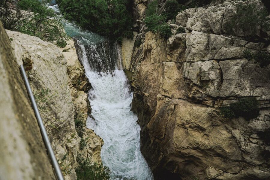 Waterfall through rocky cliffs near Caminito del Rey in Ardales