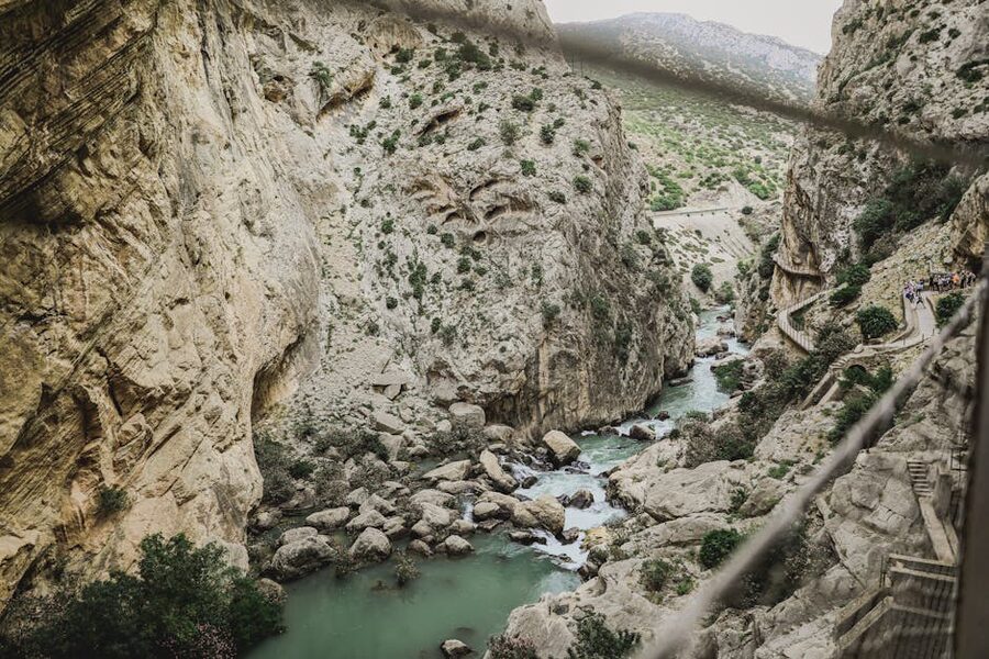 Group walking through the canyon at Caminito del Rey with the river below