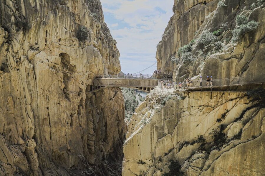 Footbridge spanning the gorge between two rocky cliffs at Caminito del Rey
