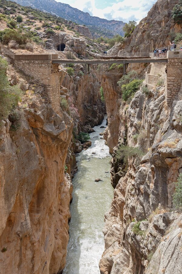 Group of visitors walking on the Caminito del Rey wooden walkway section