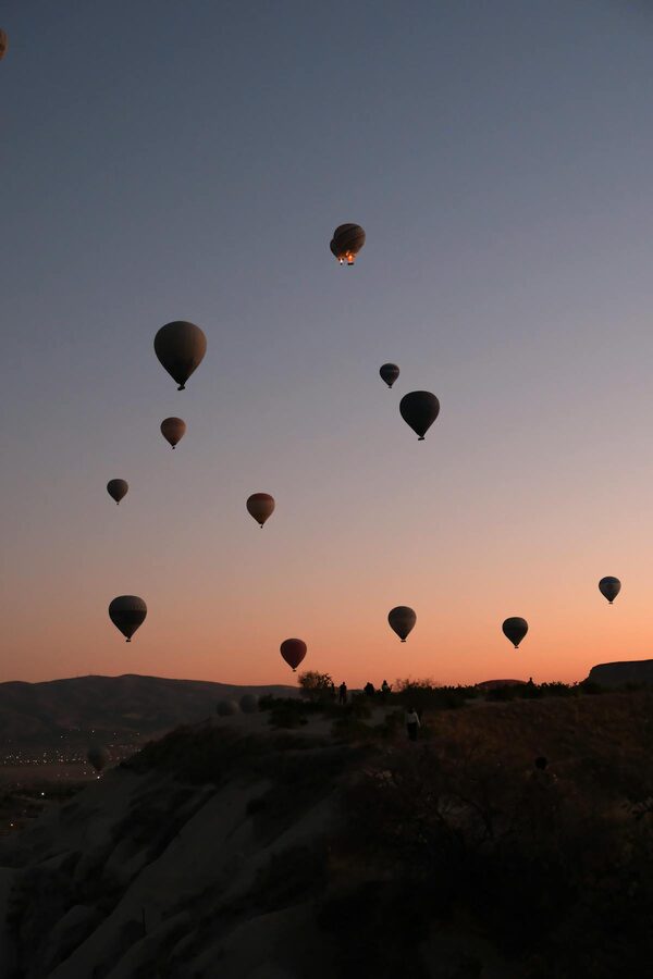 Silhouette of hot air balloons over Cappadocia at sunrise