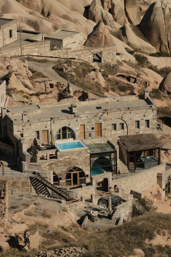 Aerial view of cave hotel among rock formations in Cappadocia
