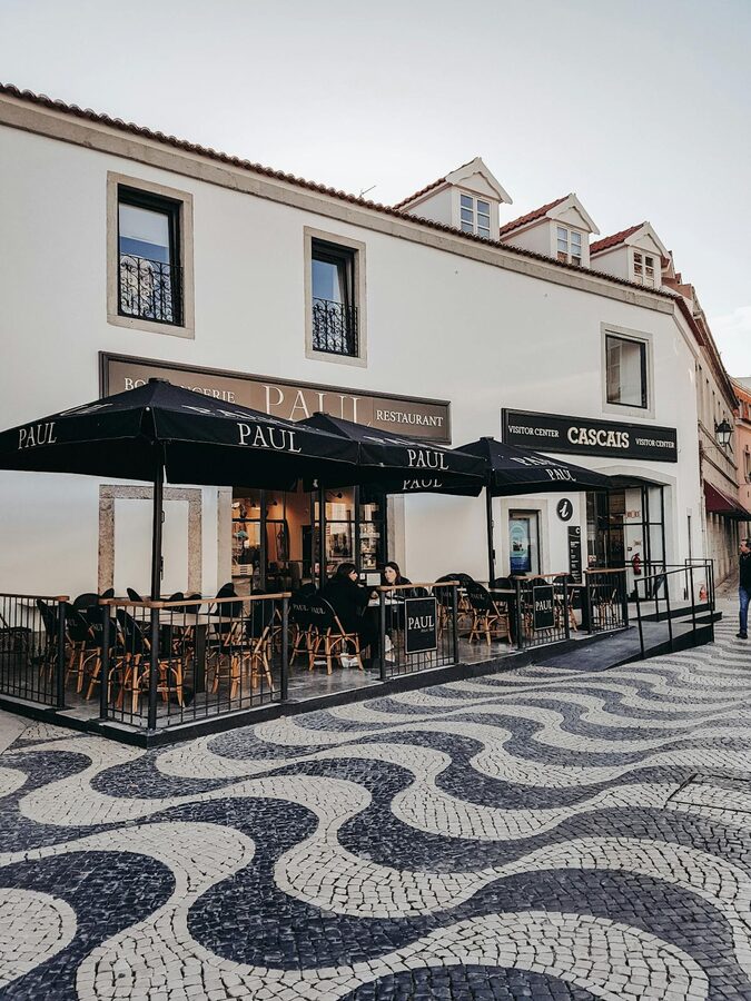 Outdoor cafe on cobblestone street in Cascais Portugal