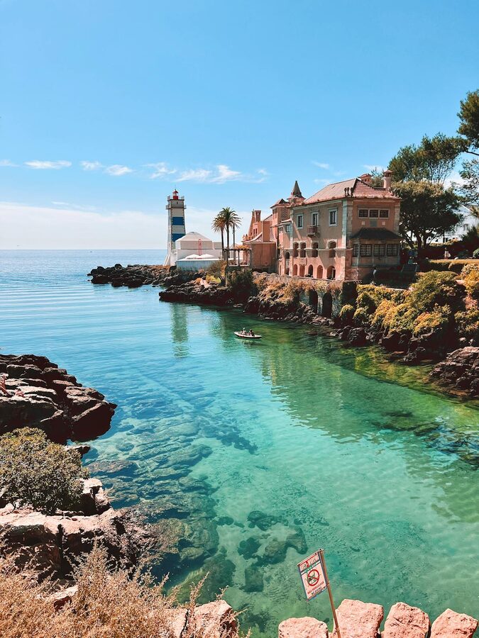 Cascais coastline with lighthouse and clear blue waters in Portugal