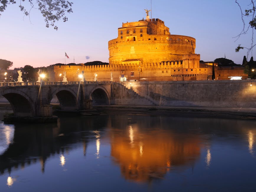Castel Sant'Angelo illuminated at sunset over the Tiber