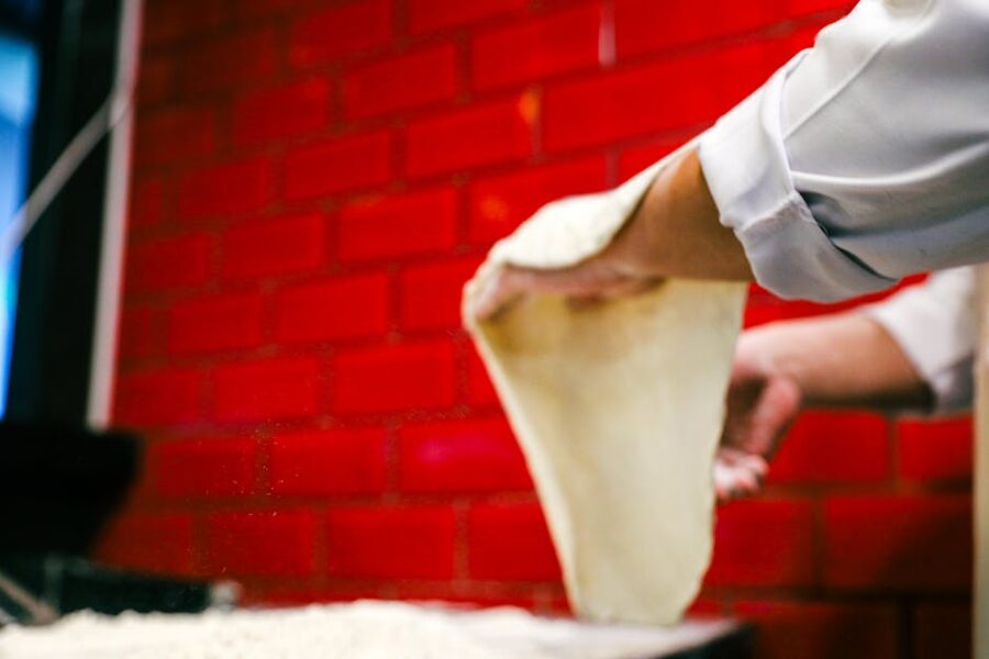 Chef stretching pizza dough