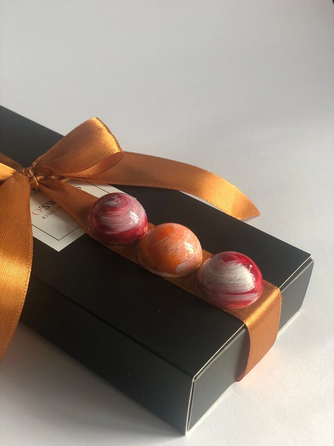 Black gift box with colourful pralines