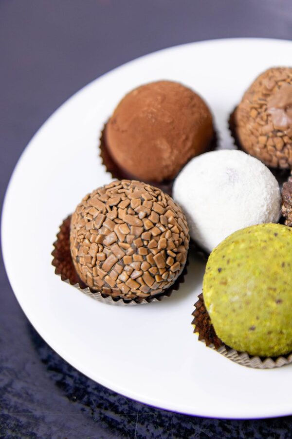 Assorted chocolate truffles on white plate