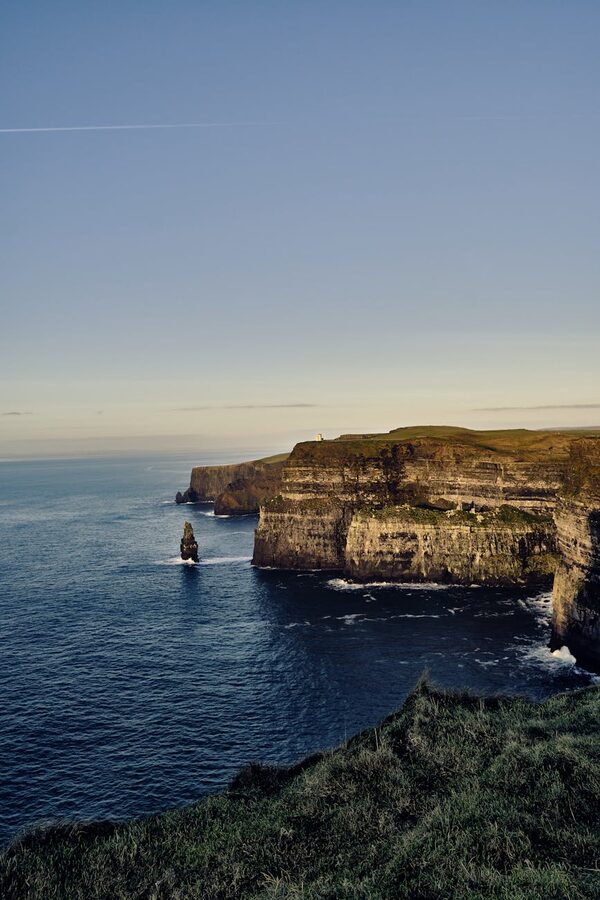 Cliffs of Moher and Atlantic Ocean waves crashing against the cliff base