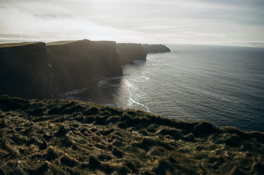 Coastal walking path along the top of the Cliffs of Moher with ocean views