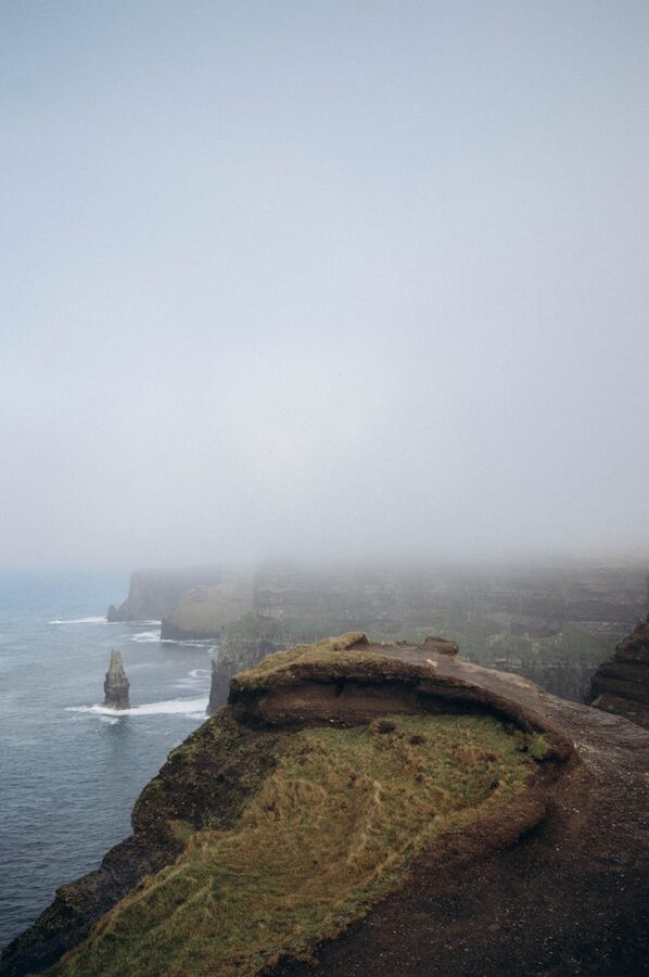 Cliffs of Moher in foggy conditions with mist rolling over the ocean