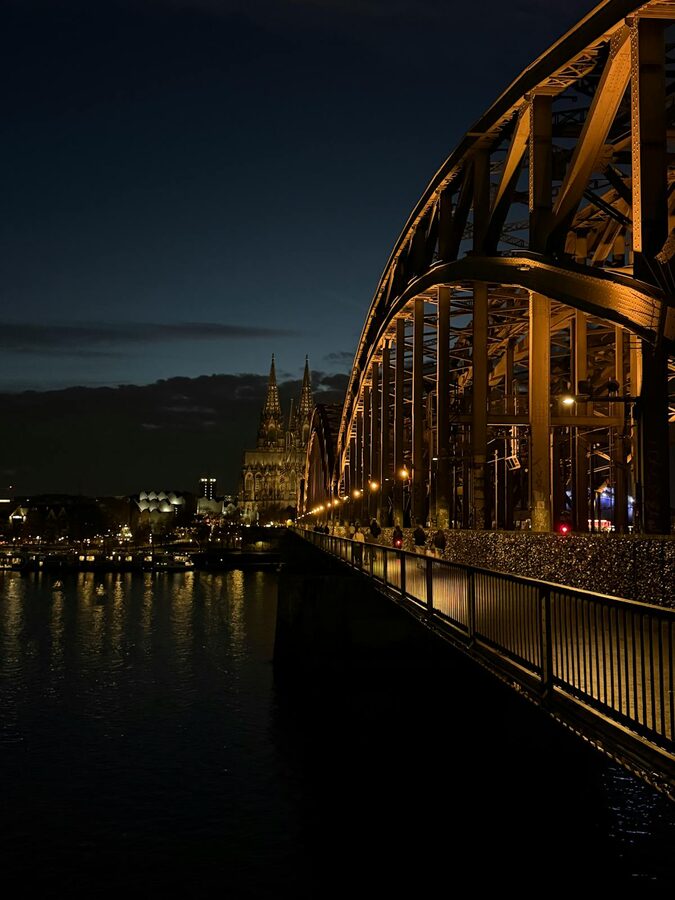 Hohenzollern Bridge and Cologne Cathedral illuminated in the evening