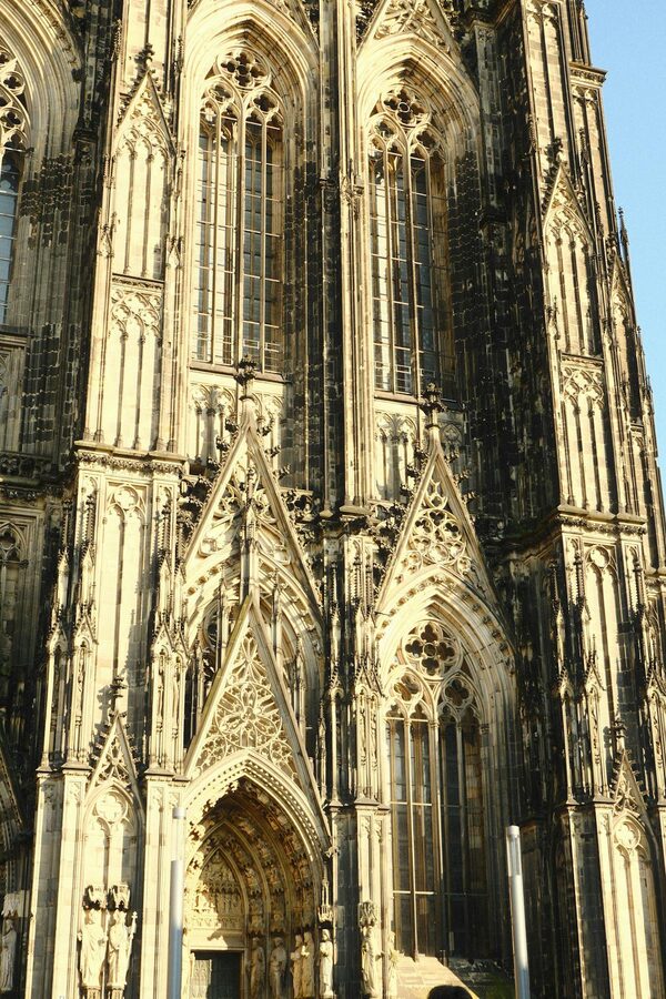Close-up of Gothic facade of Cologne Cathedral in warm sunlight