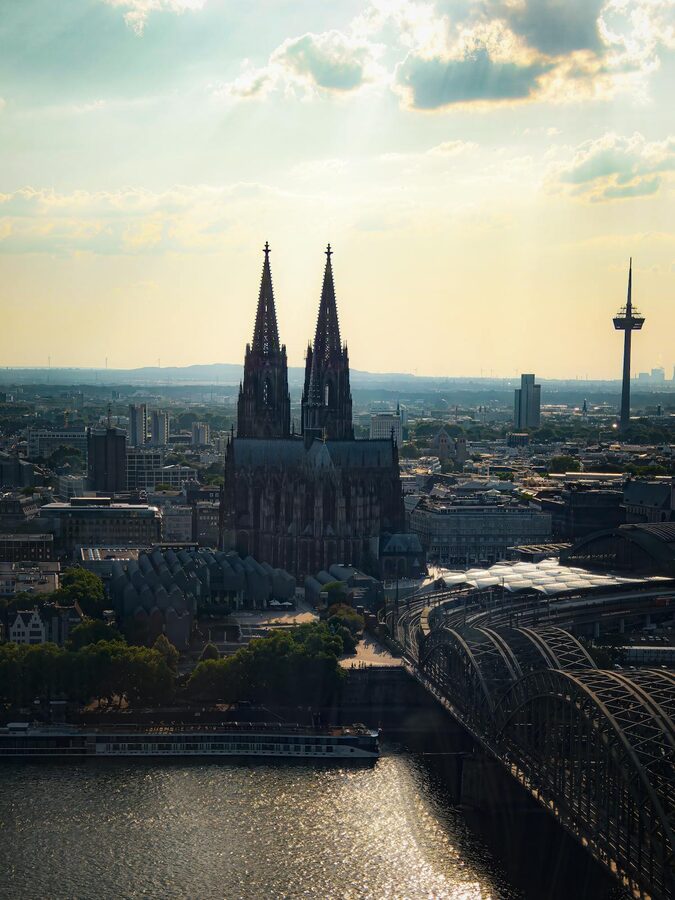 Aerial view of Cologne Cathedral and Rhine River during golden sunset