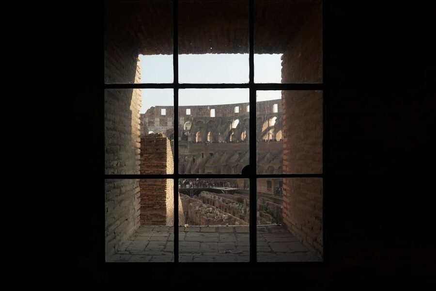 Colosseum interior view through ancient window in Rome