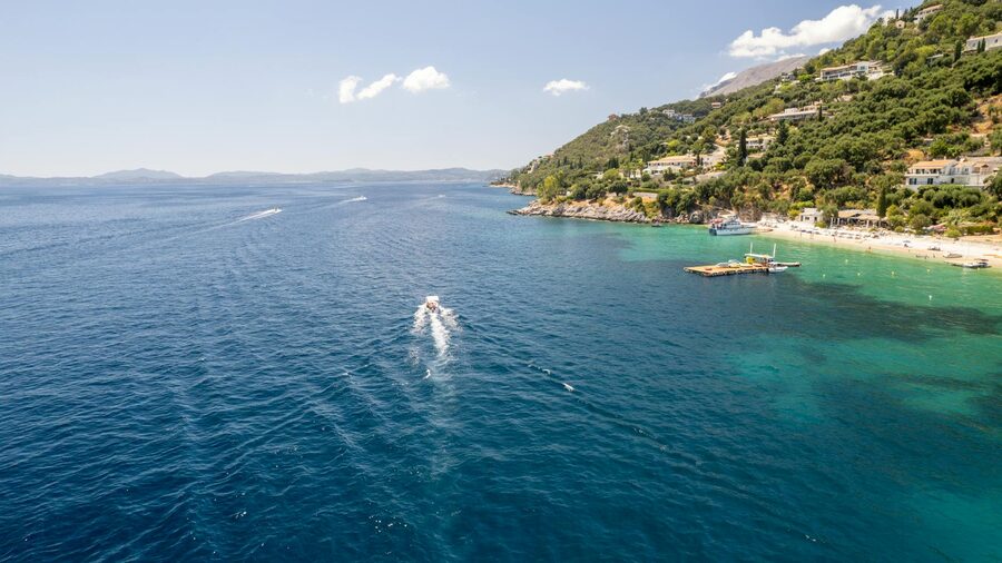 Corfu coastline with boat on blue sea