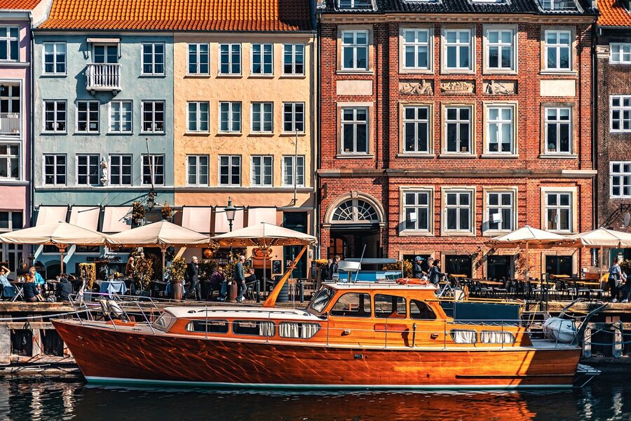Colorful canal-side buildings and boats in Copenhagen