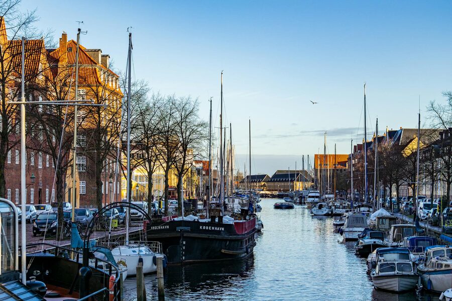 Christianshavn canal on a sunny day with boats and residential buildings