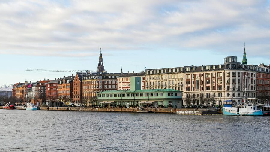 Panoramic view of Copenhagen historic waterfront with spires and old buildings