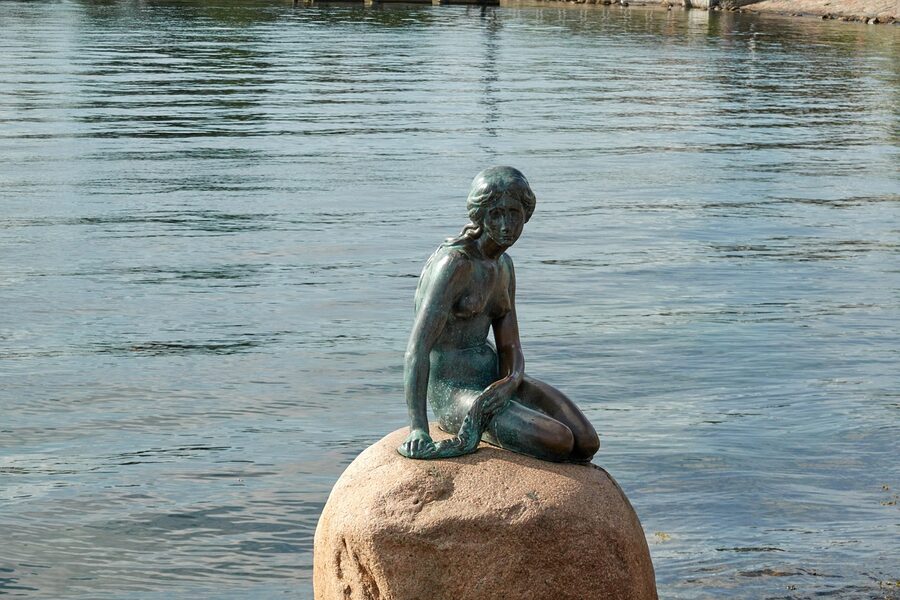 The Little Mermaid statue viewed from a distance with Copenhagen harbour