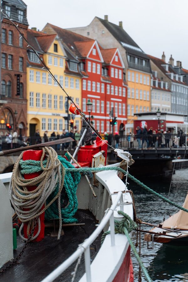 Colorful facades of Nyhavn with sailing boats moored along the canal