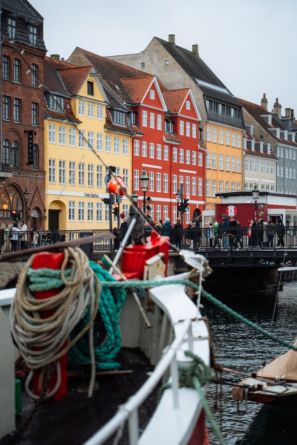 Row of colorful historic buildings along Nyhavn harbour in Copenhagen