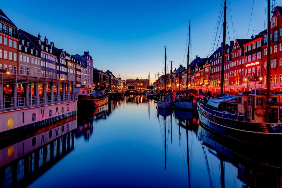Nyhavn harbour at sunset with golden light on the buildings and boats