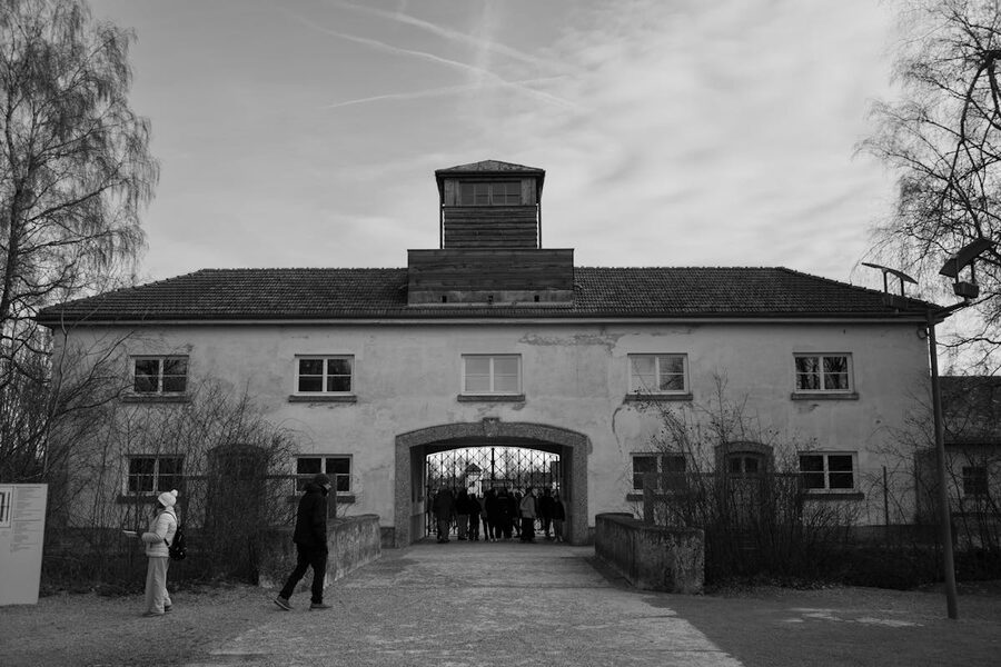 Black and white photograph of the Dachau memorial entrance area