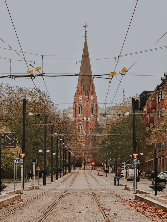 Cobblestone street leading to a church in Lund, Sweden in autumn
