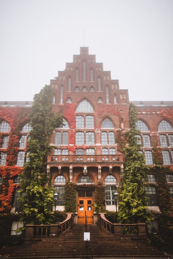 Ivy-covered university building in Lund, Sweden in misty conditions