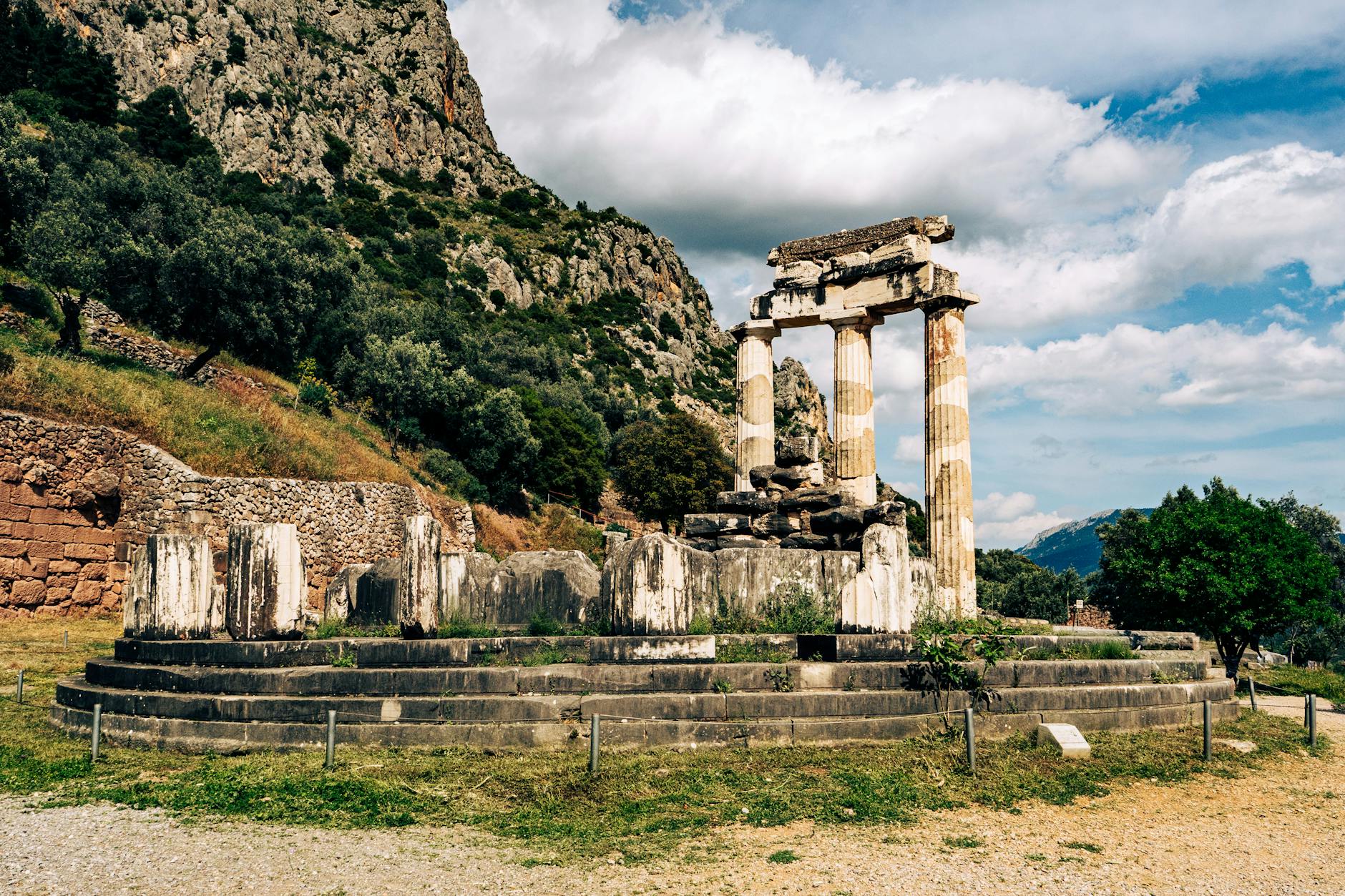 Ancient temple ruins of Delphi against a mountain backdrop