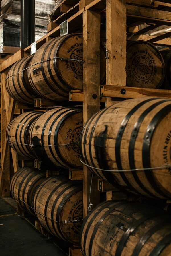 Wooden barrels stacked in a distillery indoor storage room