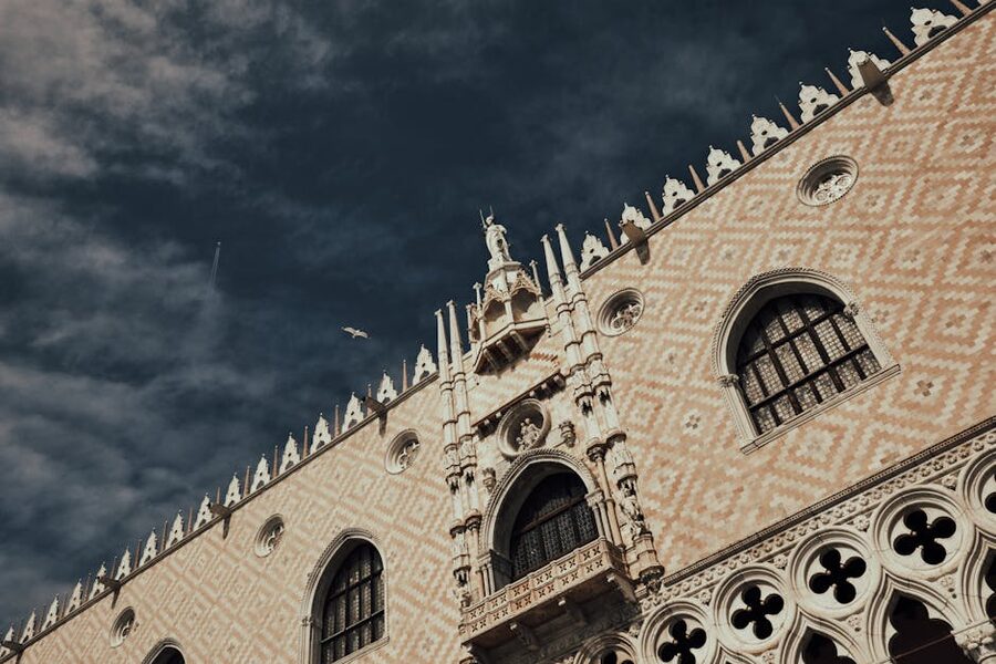 Doges Palace Gothic facade under dramatic sky in Venice
