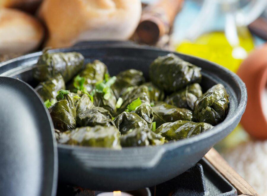 Stuffed grape leaves dolmades in a ceramic dish