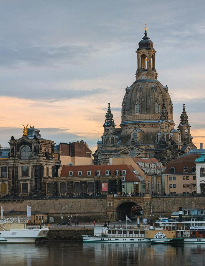 Dresden Frauenkirche dome and architecture by the river at sunset