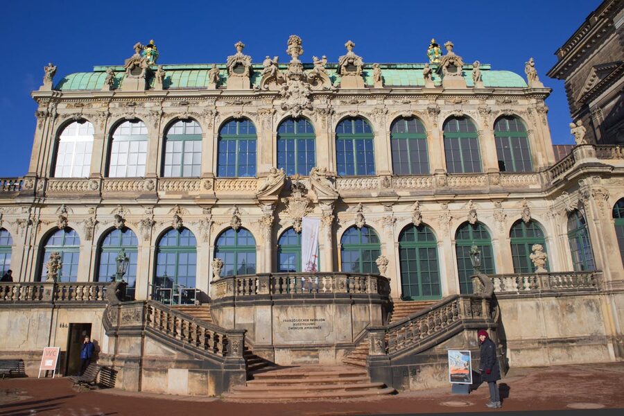 Front view of Zwinger Palace in Dresden showing Baroque architecture under clear blue sky