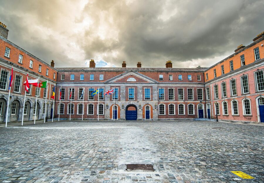 Dublin Castle courtyard with flags and classical architecture