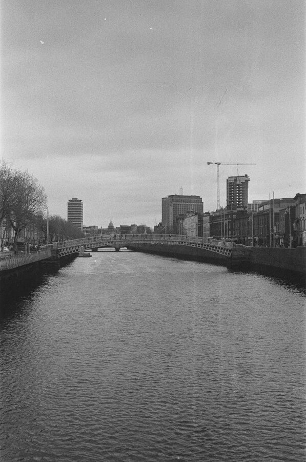 River Liffey bridge and Dublin city buildings at dusk
