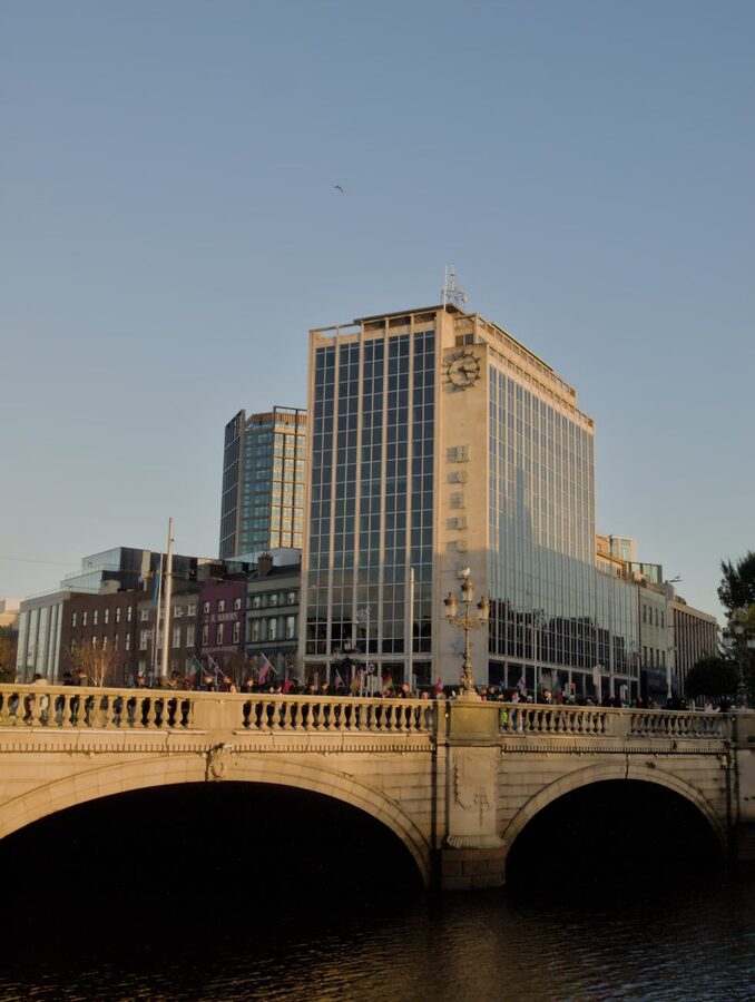 Modern Dublin bridge at sunset with warm orange light