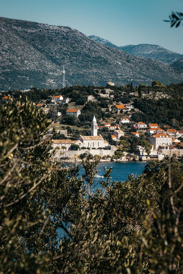 Lopud Island coastline with church and green hillside