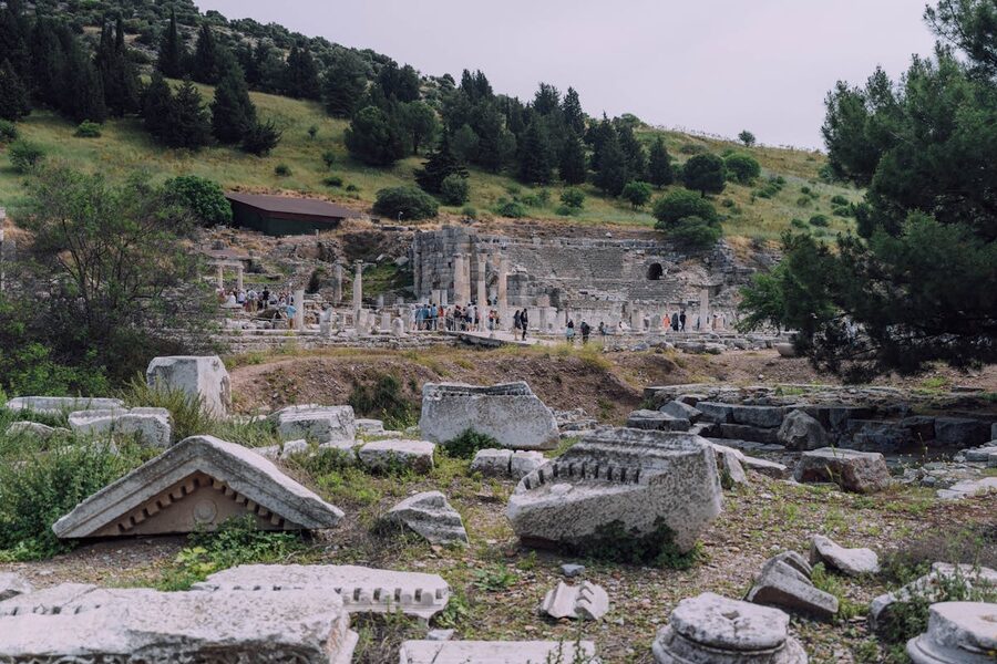 Wide view of Ephesus archaeological site with ruins stretching across a green hillside