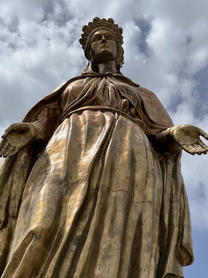 Statue of the Virgin Mary against a cloudy sky in Izmir Turkey