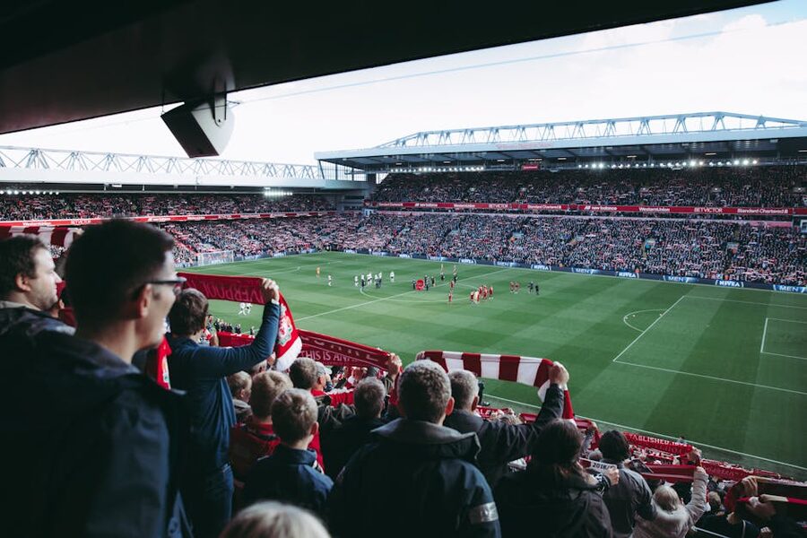 Fans cheering players at football match
