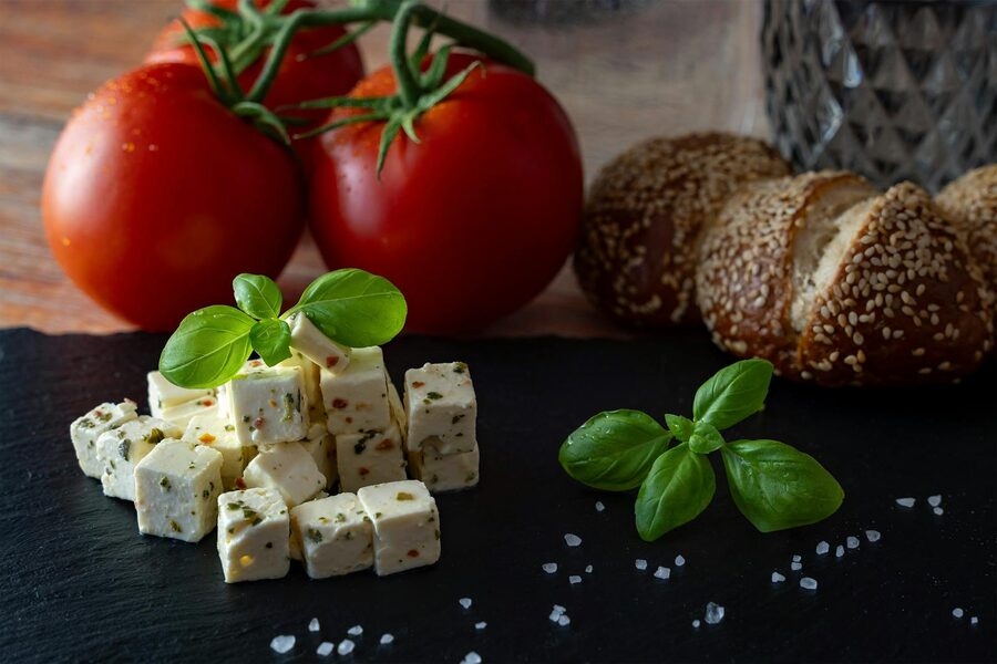 Fresh feta cheese cubes with tomato and basil